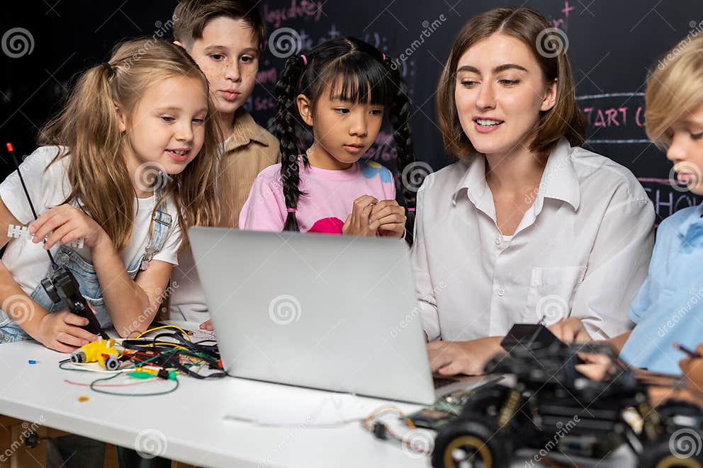 Teacher Demonstrate Attentive Children To Code Robots in STEM Class. Erudition. Stock Photo ...