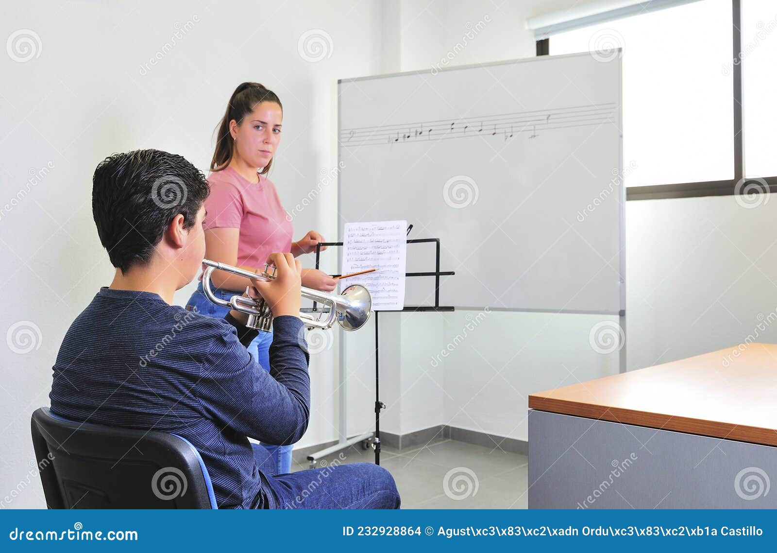 Teacher Corrects Music in the Classroom, To a Young Student Stock Photo ...