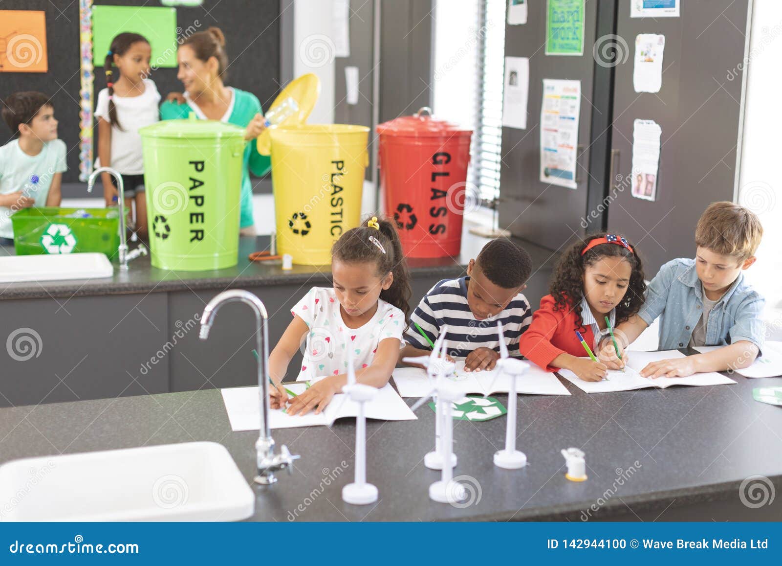 Teacher Discussing about Green Energy while Students Studying in ...