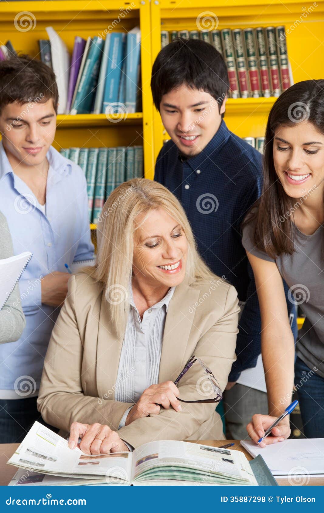 Teacher Discussing with Students at Table in Stock Photo - Image of ...