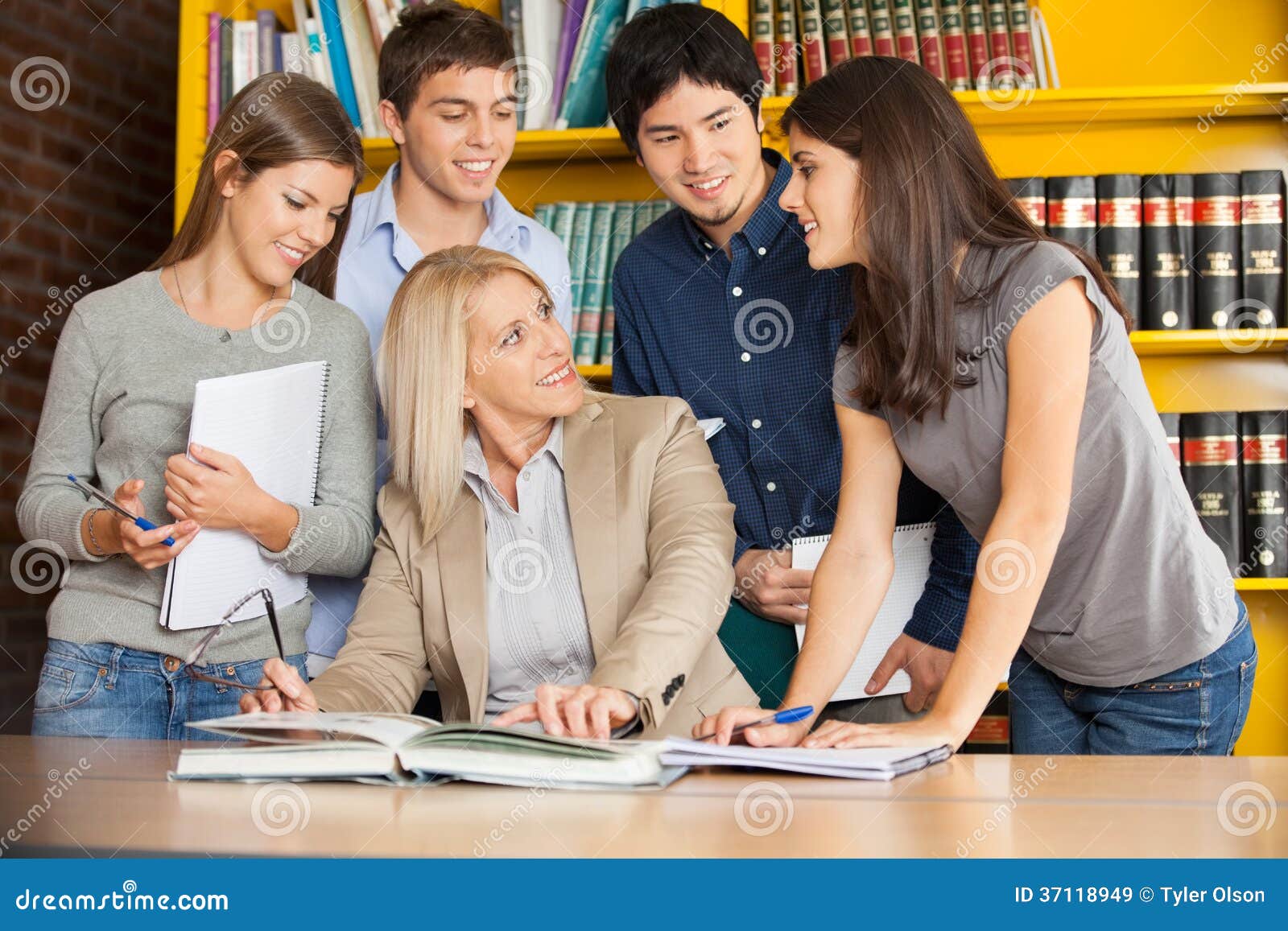 Teacher Discussing with Students at Table in Stock Image - Image of ...