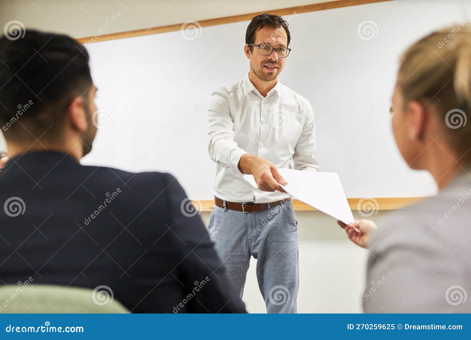 Teacher Distributes Questionnaires for a Test in a Seminar Stock Image ...