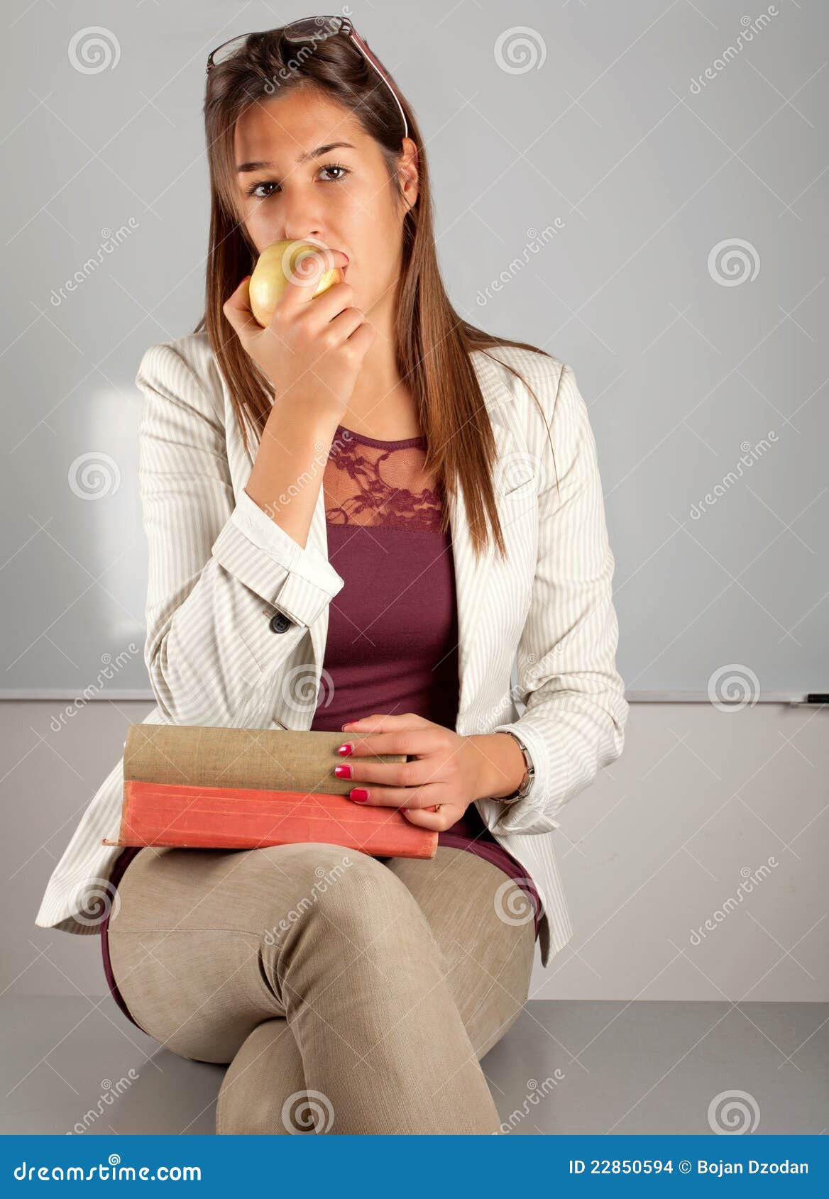 Teacher Eat Apple At Desk Stock Images - Image: 22850594
