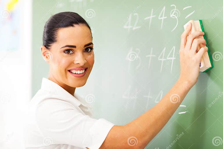 Teacher erasing chalkboard stock photo. Image of green - 29287576