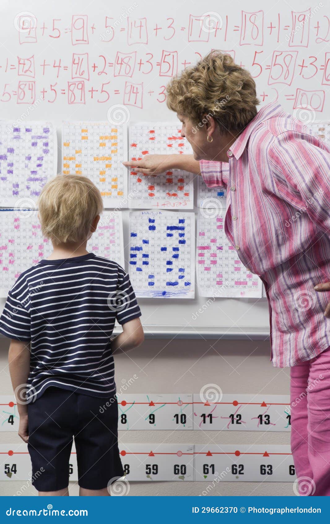 Teacher Explaining Calendar To Little Boy Stock Photo - Image of ...