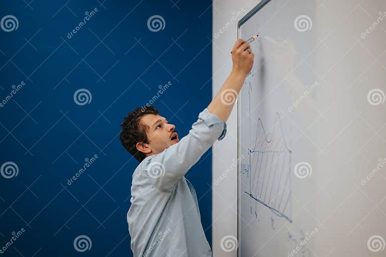 Teacher Explaining Graph on Whiteboard during Classroom Lecture Stock ...