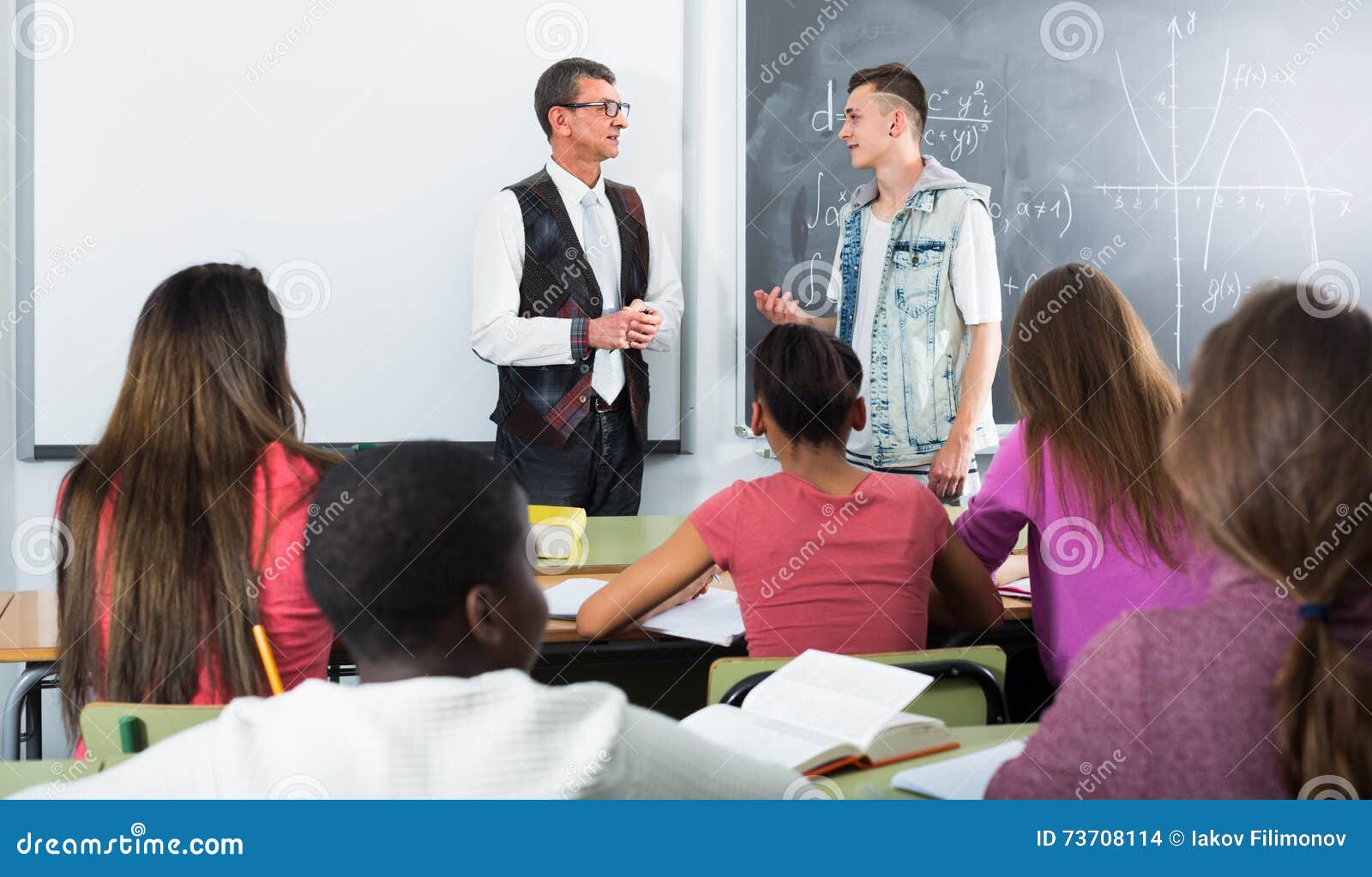 Teacher Explaining the Math Near Chalkboard Stock Photo - Image of ...