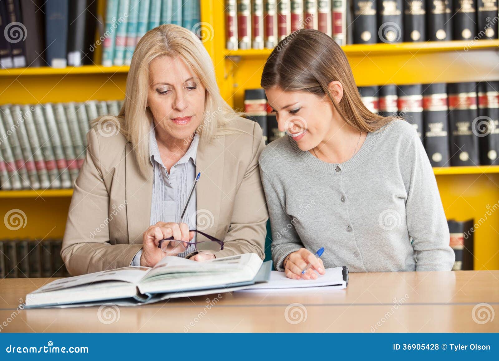 Teacher Explaining Student in College Library Stock Photo - Image of ...