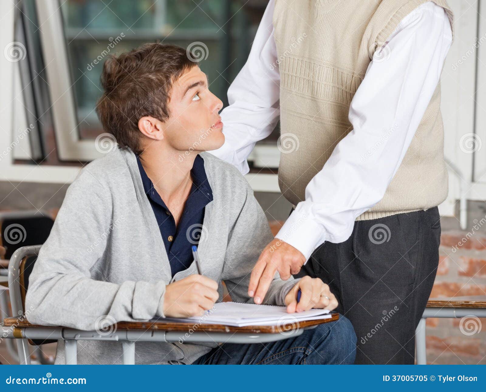 Teacher Explaining Test To Student in Classroom Stock Image - Image of ...