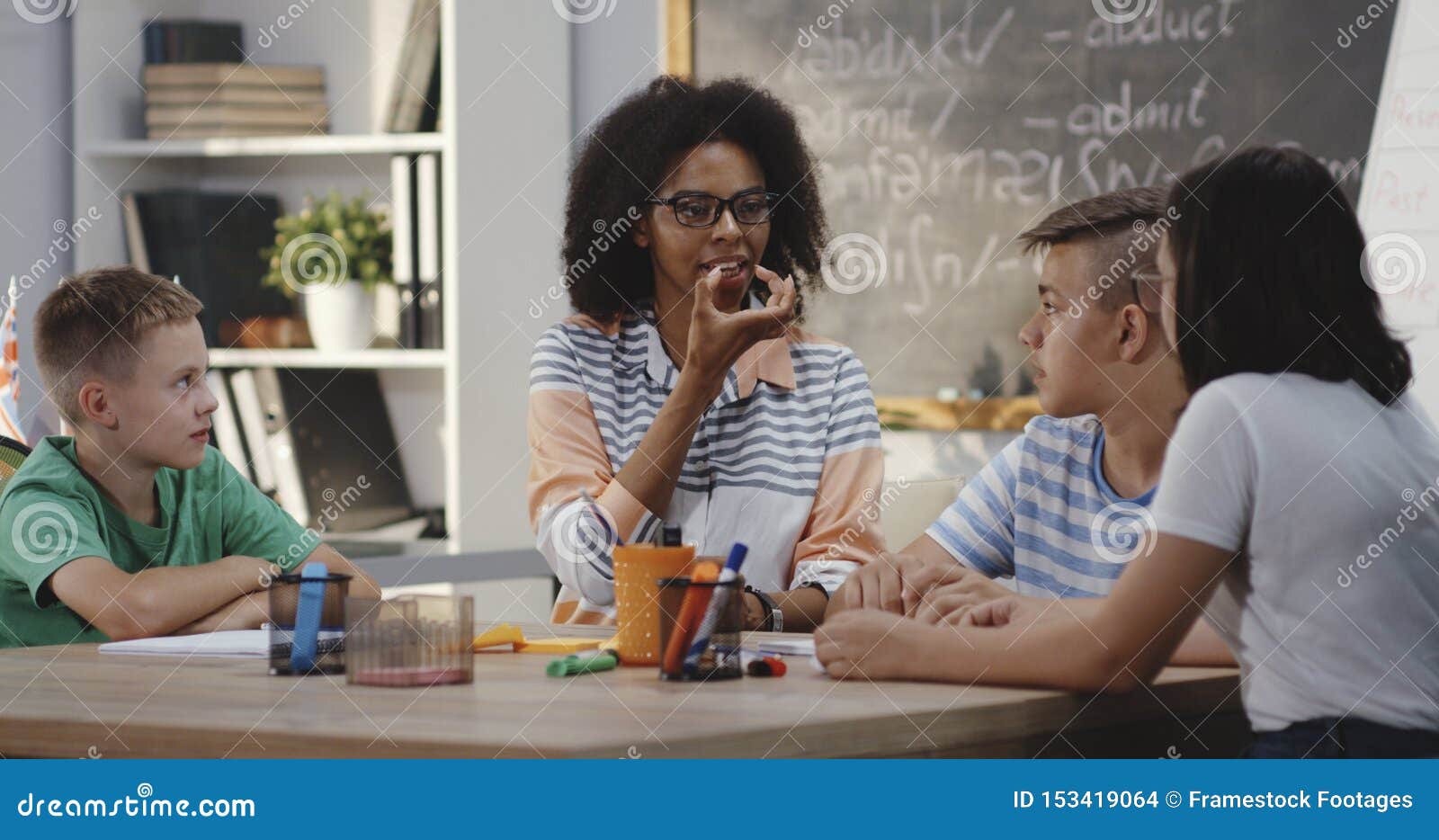 Teacher Explaining To Pupils in a Classroom Stock Photo - Image of ...