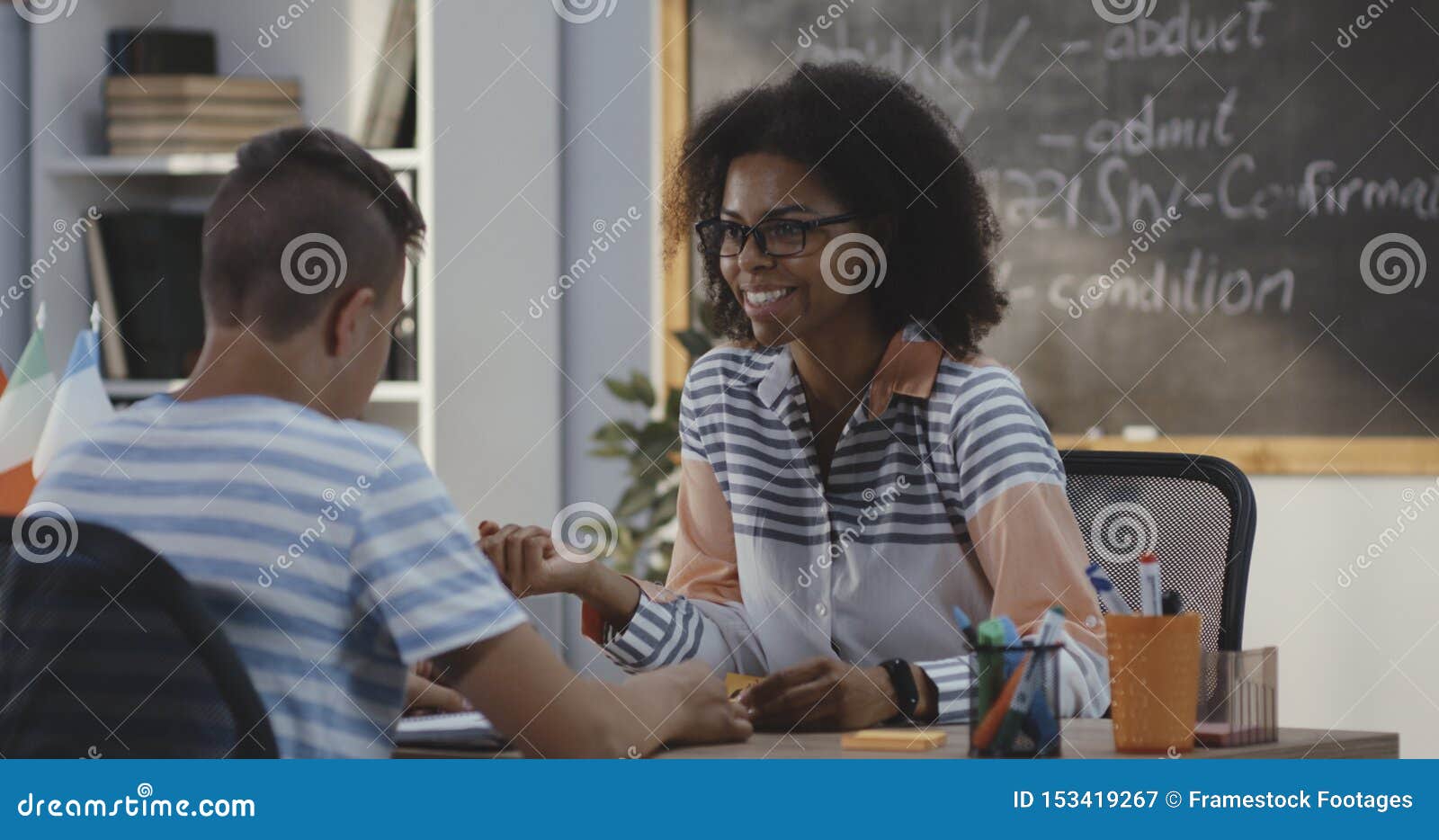 Teacher Explaining To Student in a Classroom Stock Image - Image of ...