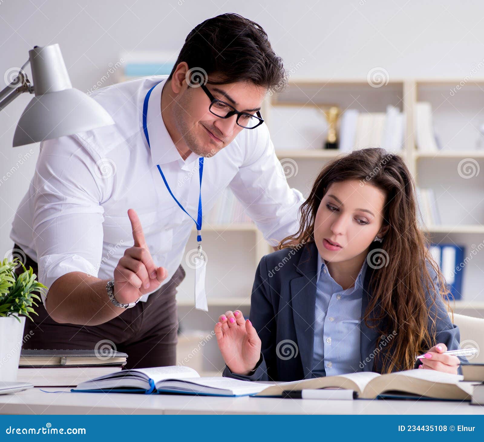 Teacher Explaining To Student at Lecture Stock Photo - Image of ...