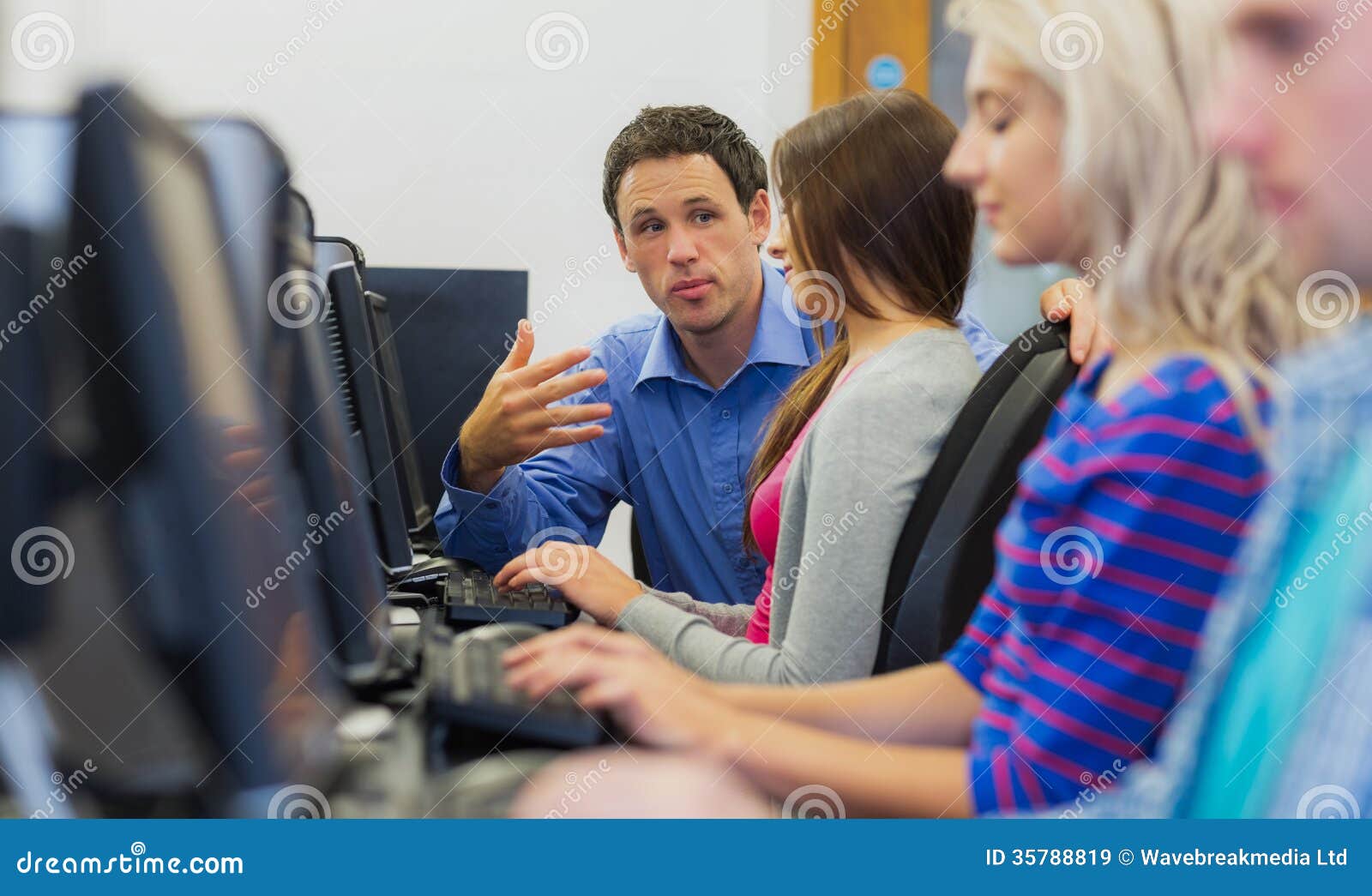 Teacher Explaining To Students in the Computer Room Stock Image - Image ...
