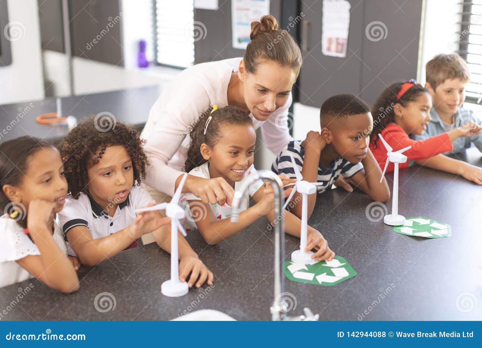 Teacher Explaining about Windmill To School Kids at School in Classroom ...