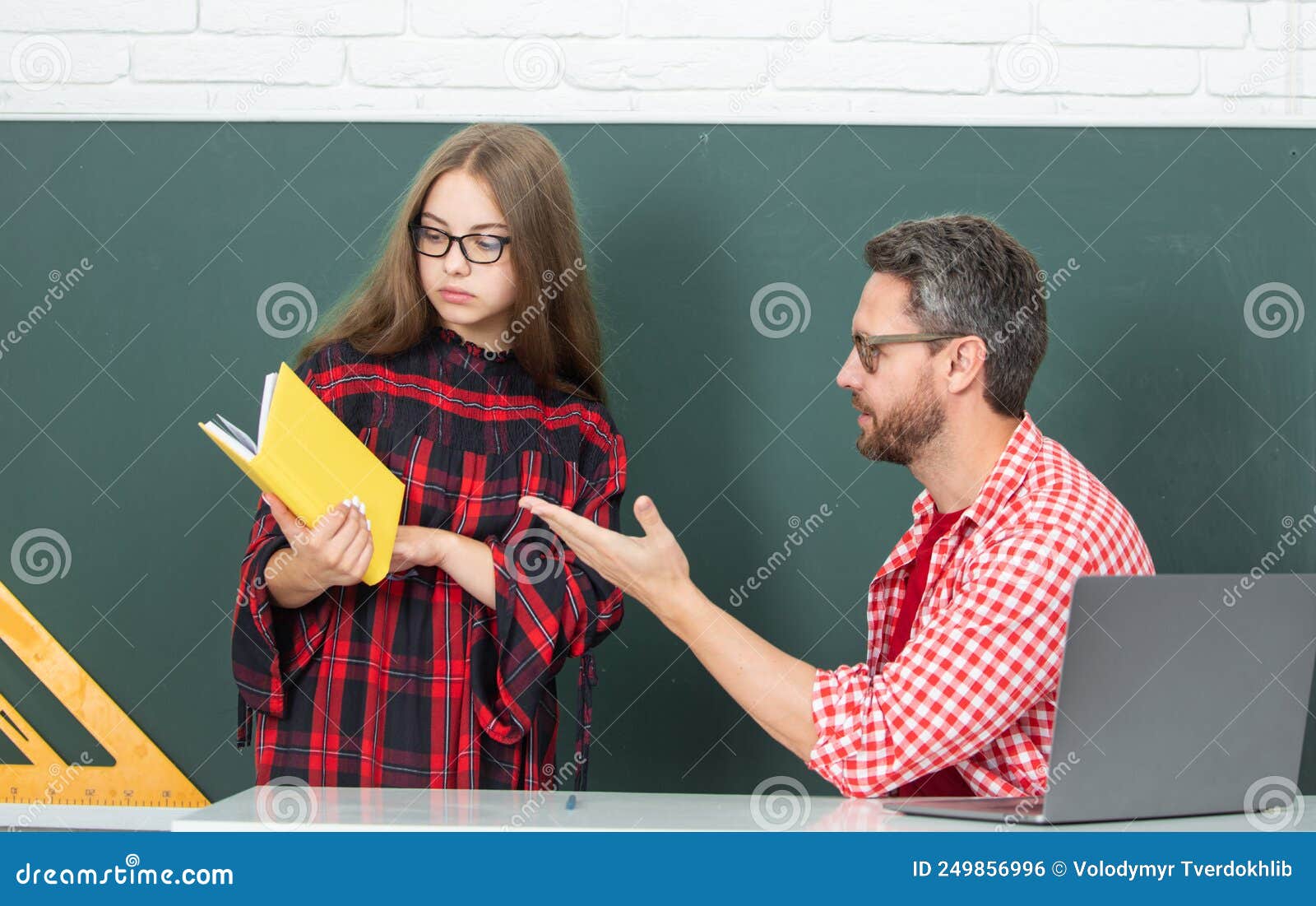 Teacher Explains Lesson To School Child. Elementary School Kids ...