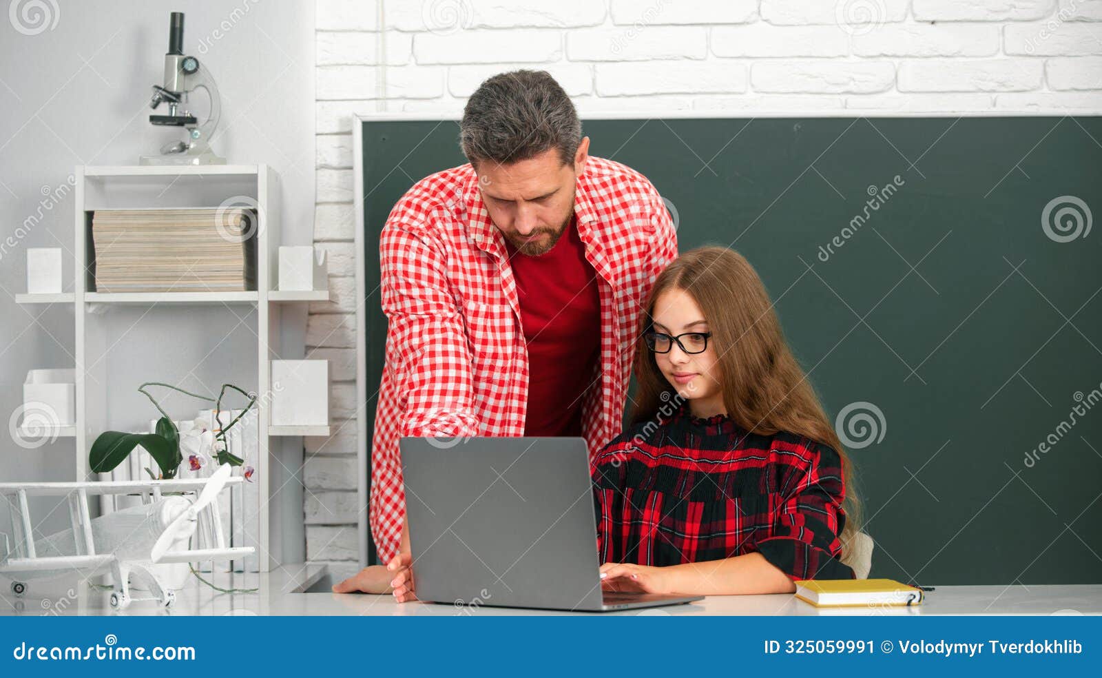 Teacher Explains Lesson To School Child. Elementary School Kids ...