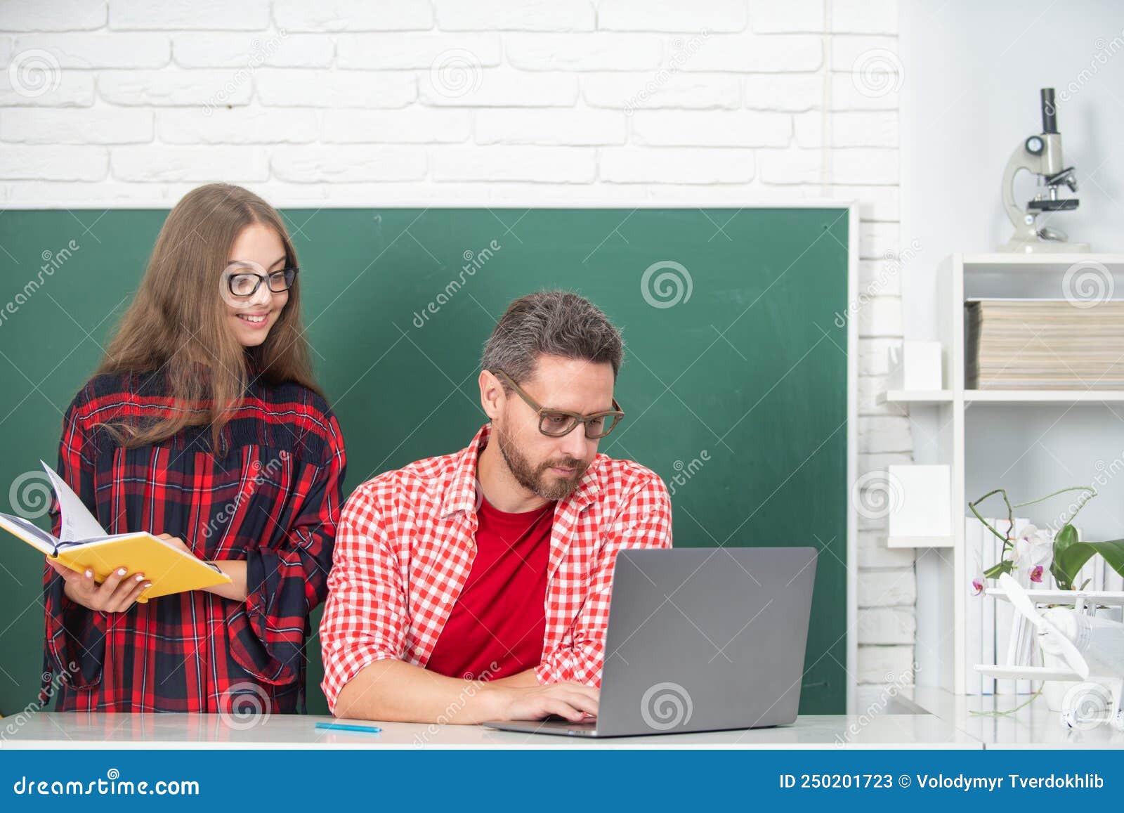 Teacher Explains Lesson To School Child. Elementary School Kids ...