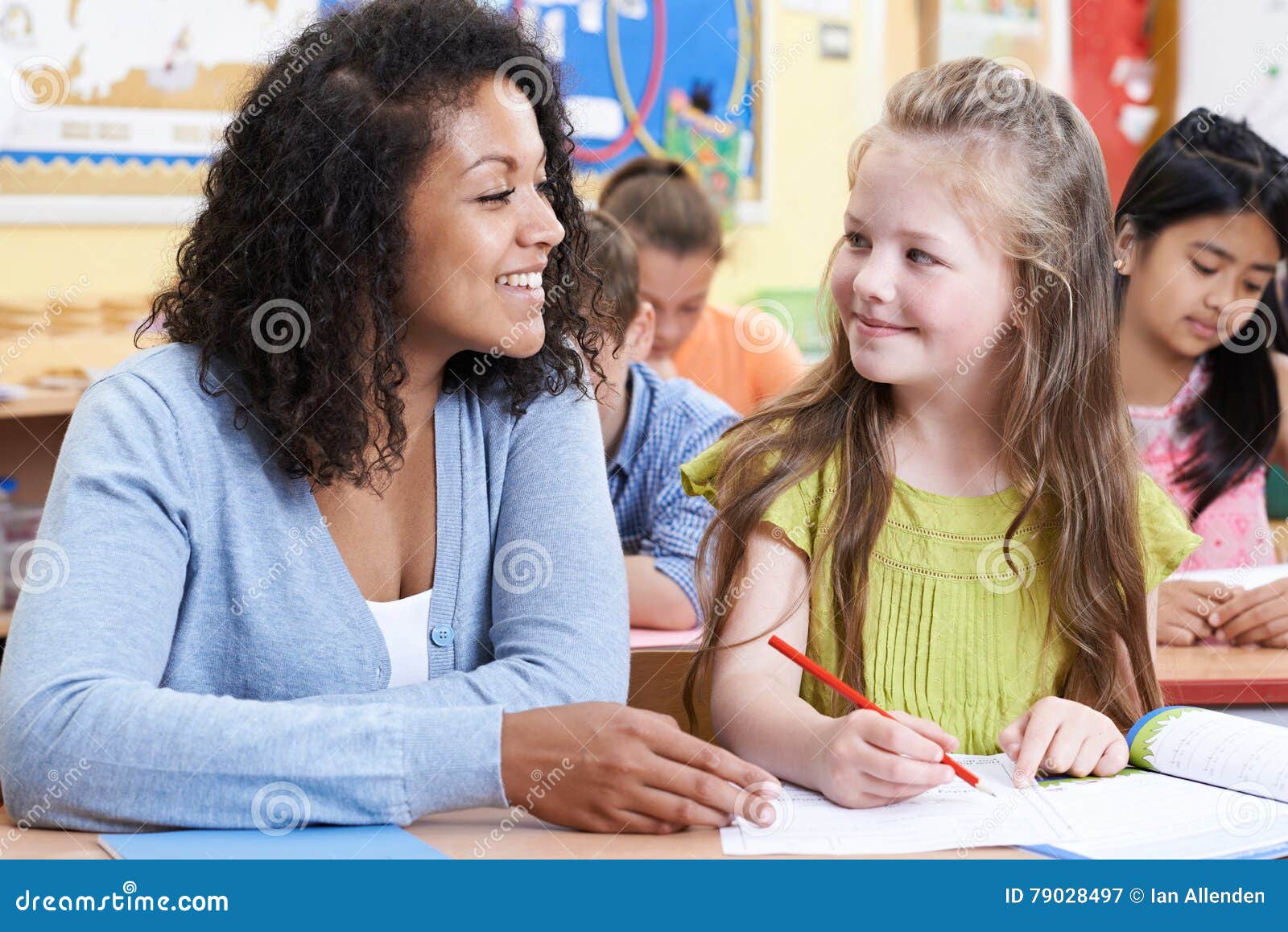 Teacher with Female Elementary School Pupil in Class Stock Image ...
