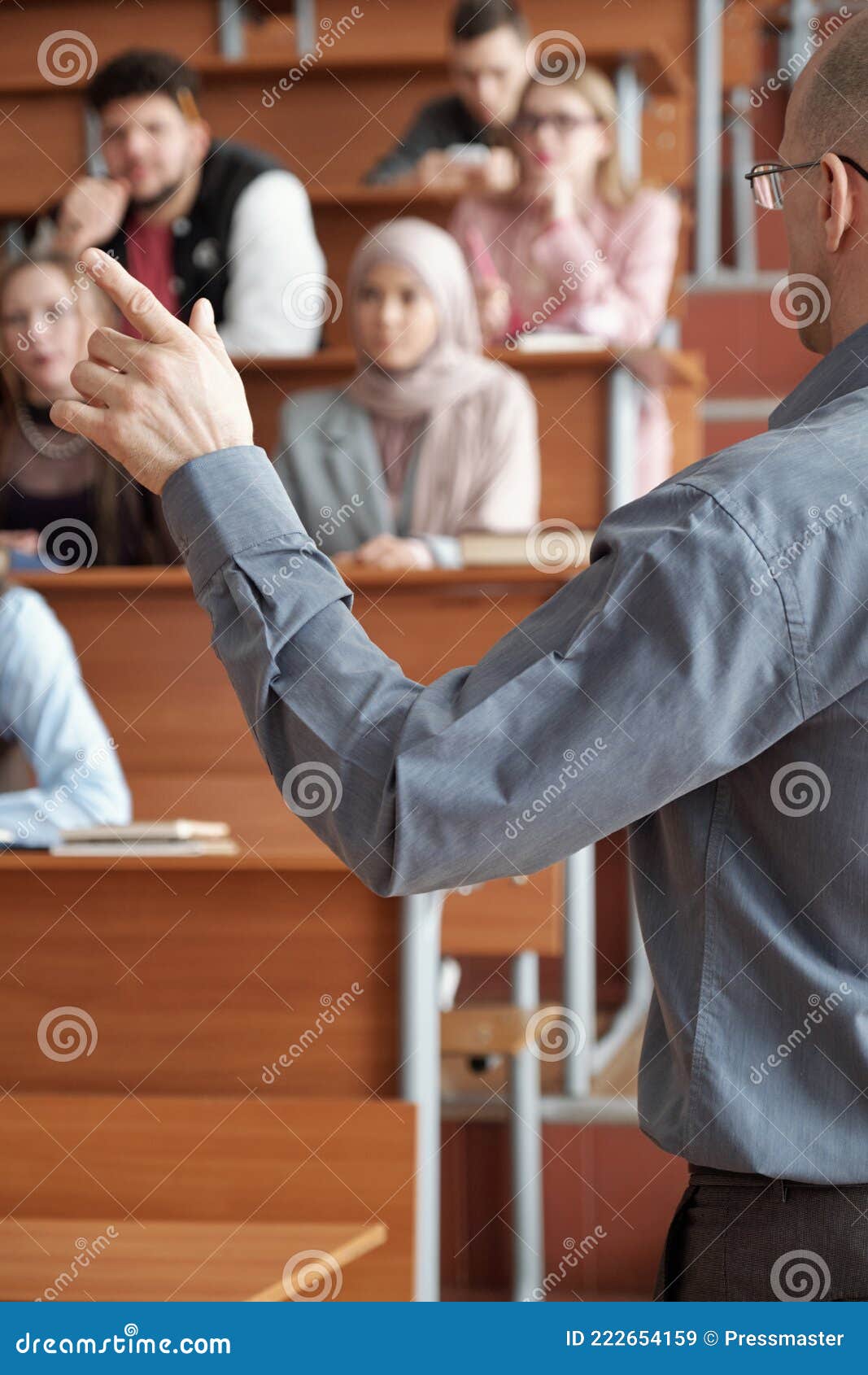 Teacher Gesturing in Front of Group of Students Stock Image - Image of ...