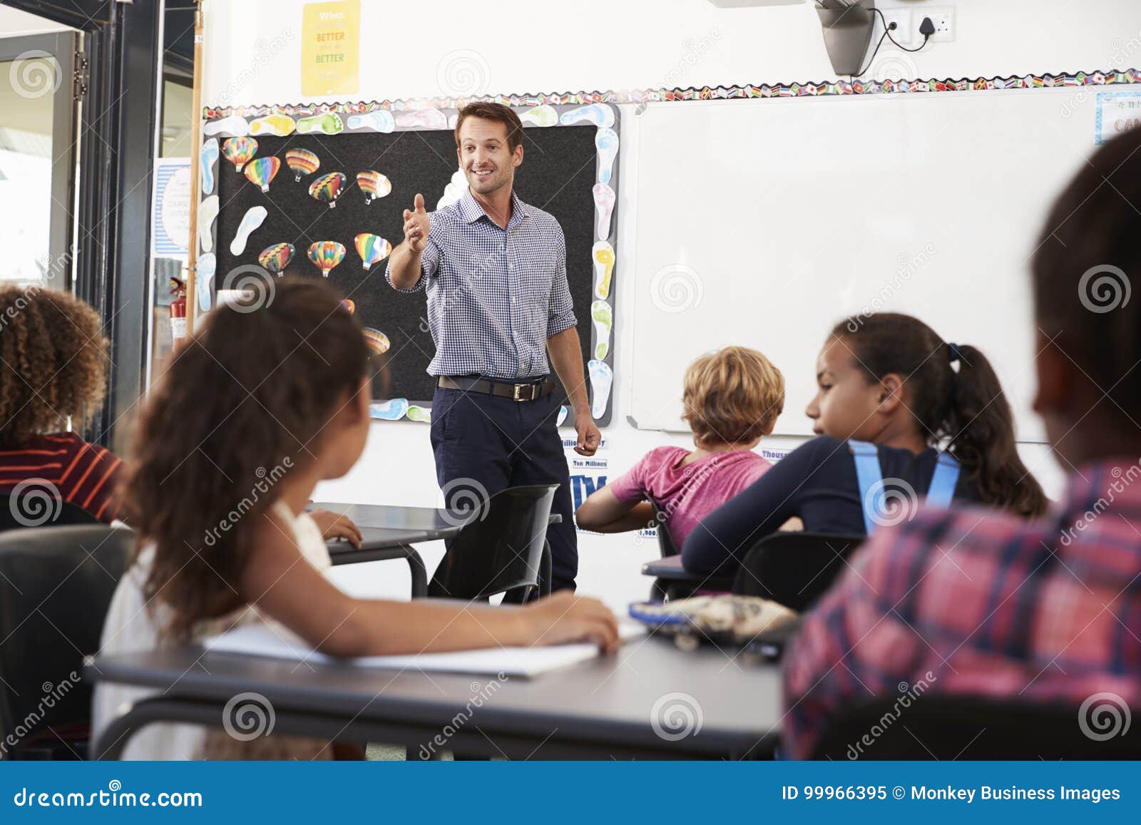 Teacher Gesturing To Class in an Elementary School Lesson Stock Image ...