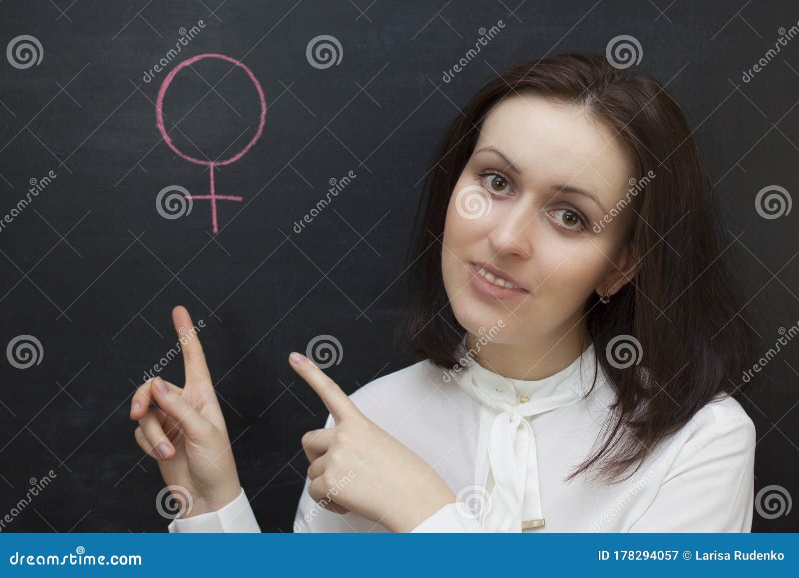 Teacher Girl At The Chalkboard Shows The Gender Symbol Of A Woman Sex