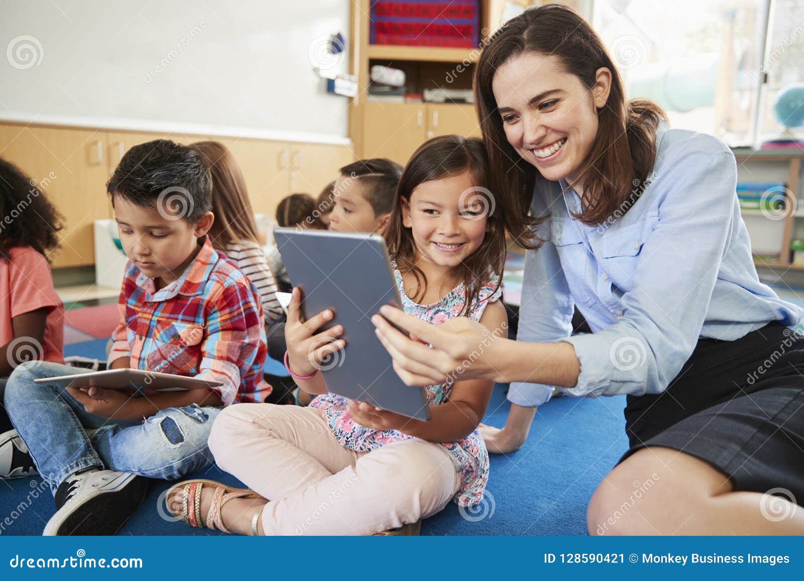Teacher and Girl in Elementary Class Using Tablet Computers Stock Image ...
