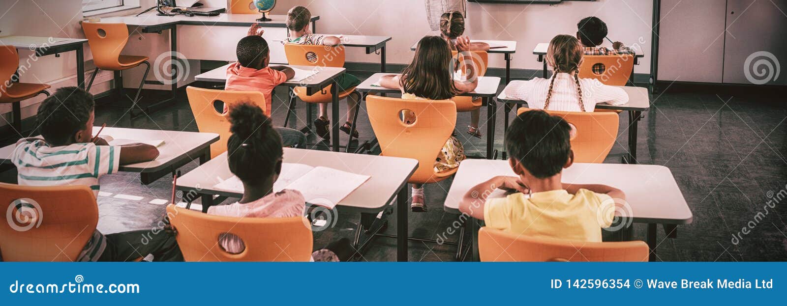 Teacher Giving Lesson To Her Students Stock Photo - Image of boys ...