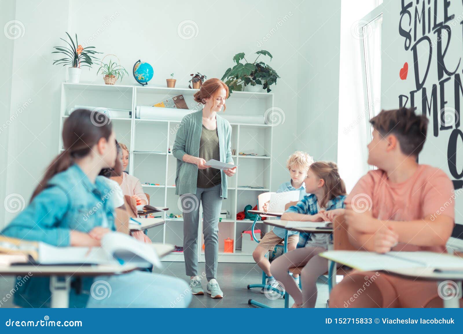 Teacher Giving Pupils Sheets of Paper with the Test. Stock Image ...