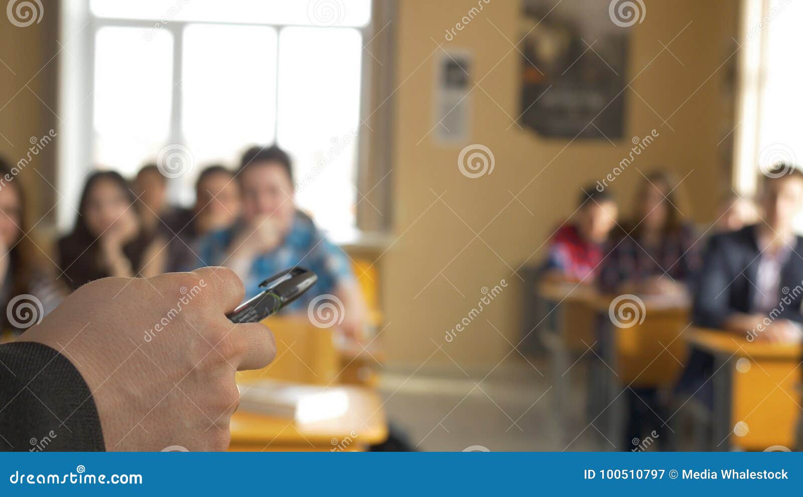 Teacher with a Group of High School Students in Classroom. View from ...
