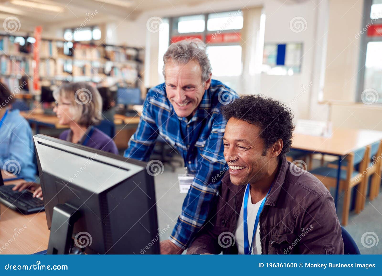 Teacher with Group of Mature Adult Students in Class Working at ...