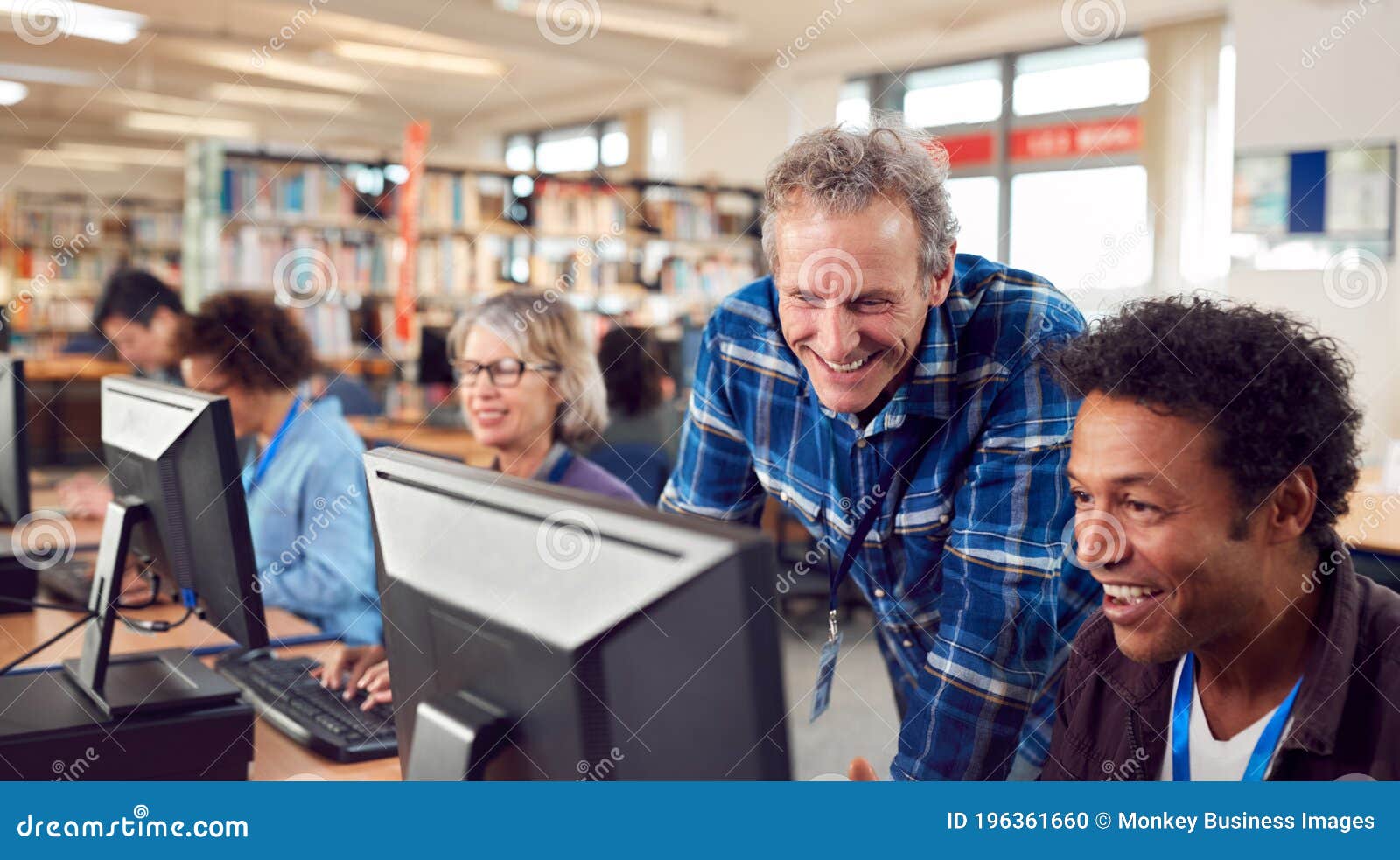 Teacher with Group of Mature Adult Students in Class Working at ...