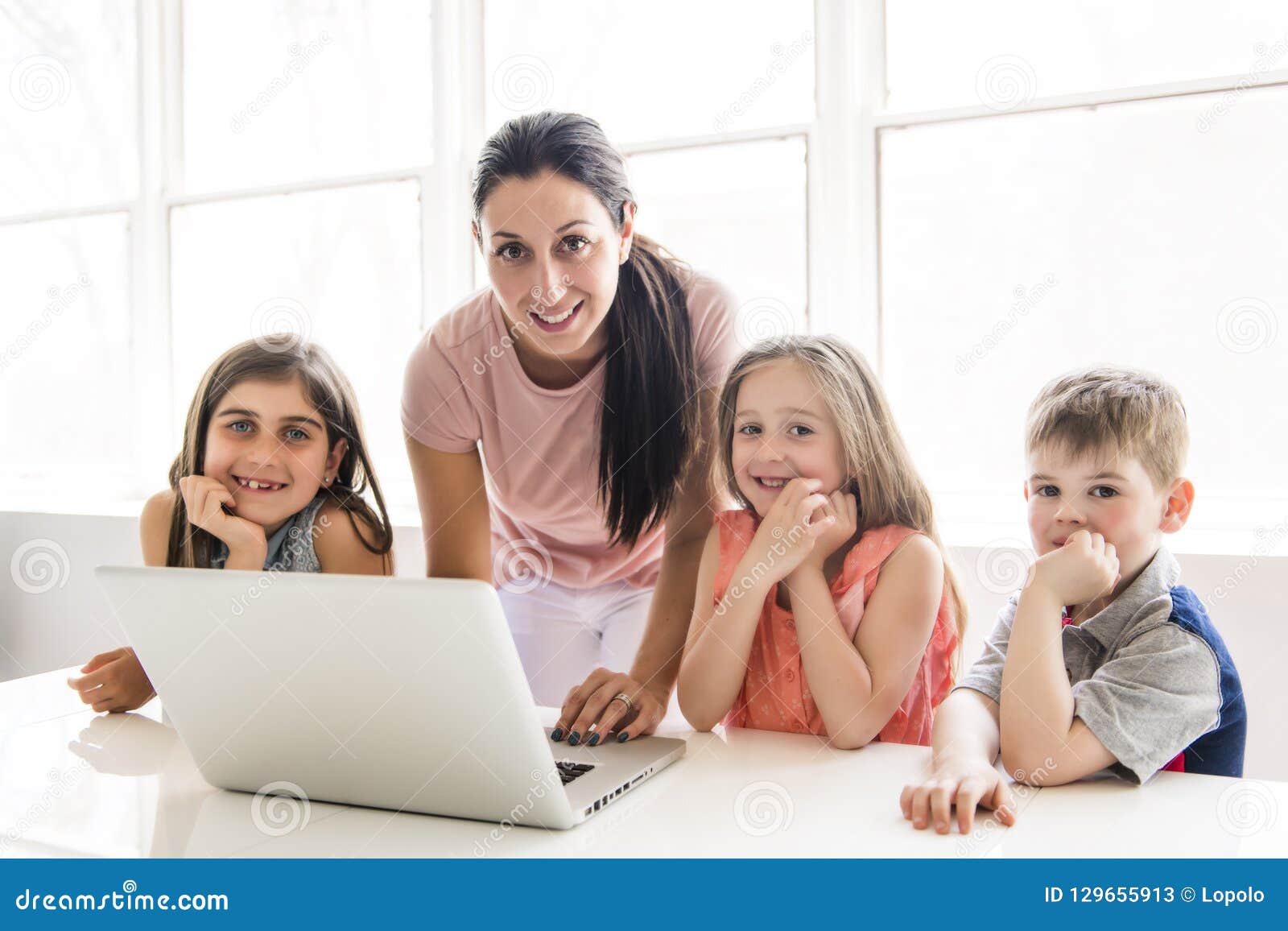 Teacher with a Group of School Children with Laptop on the Front Stock ...