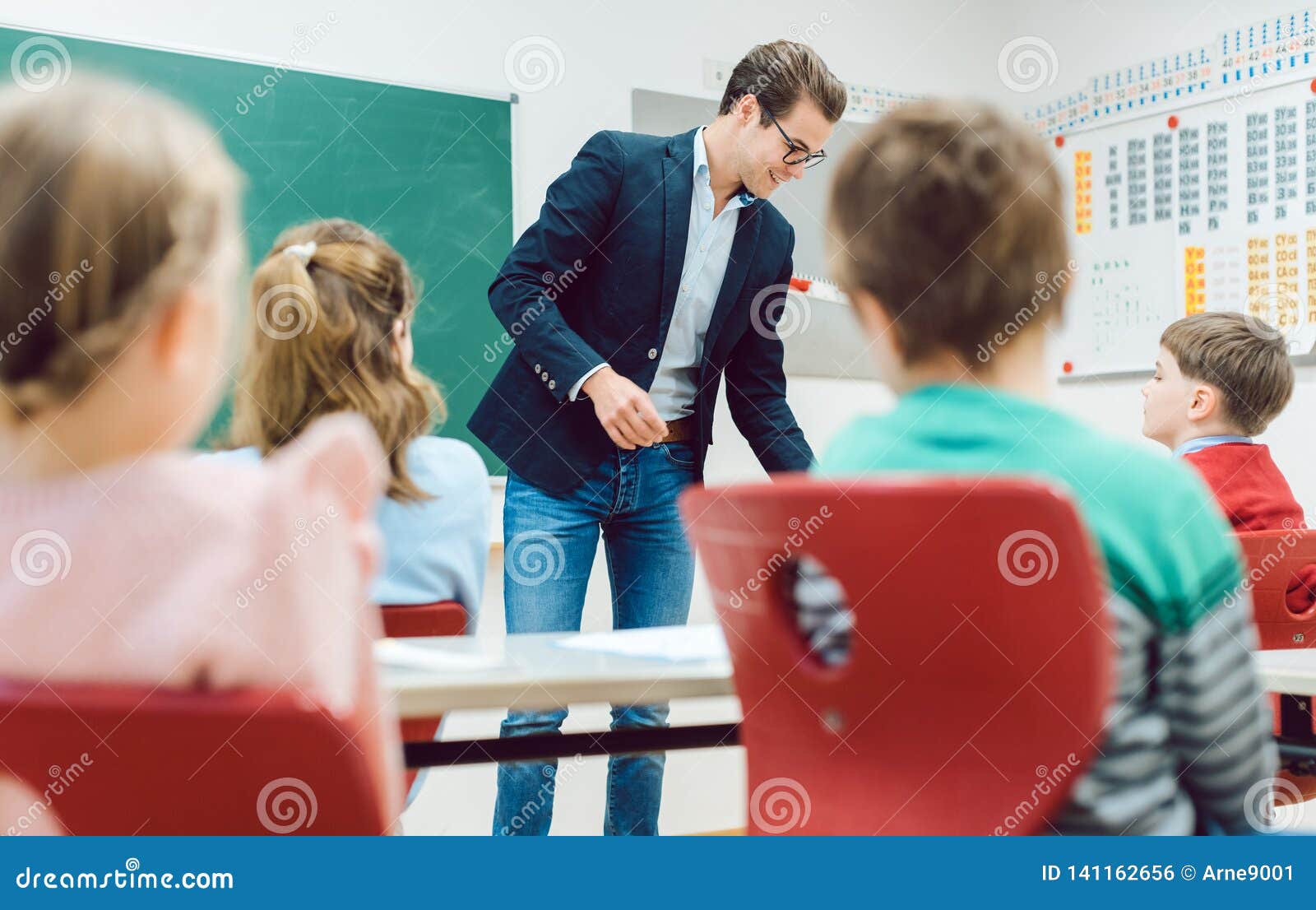 Teacher Handing Paper To Student In Class Royalty-Free Stock Photo ...