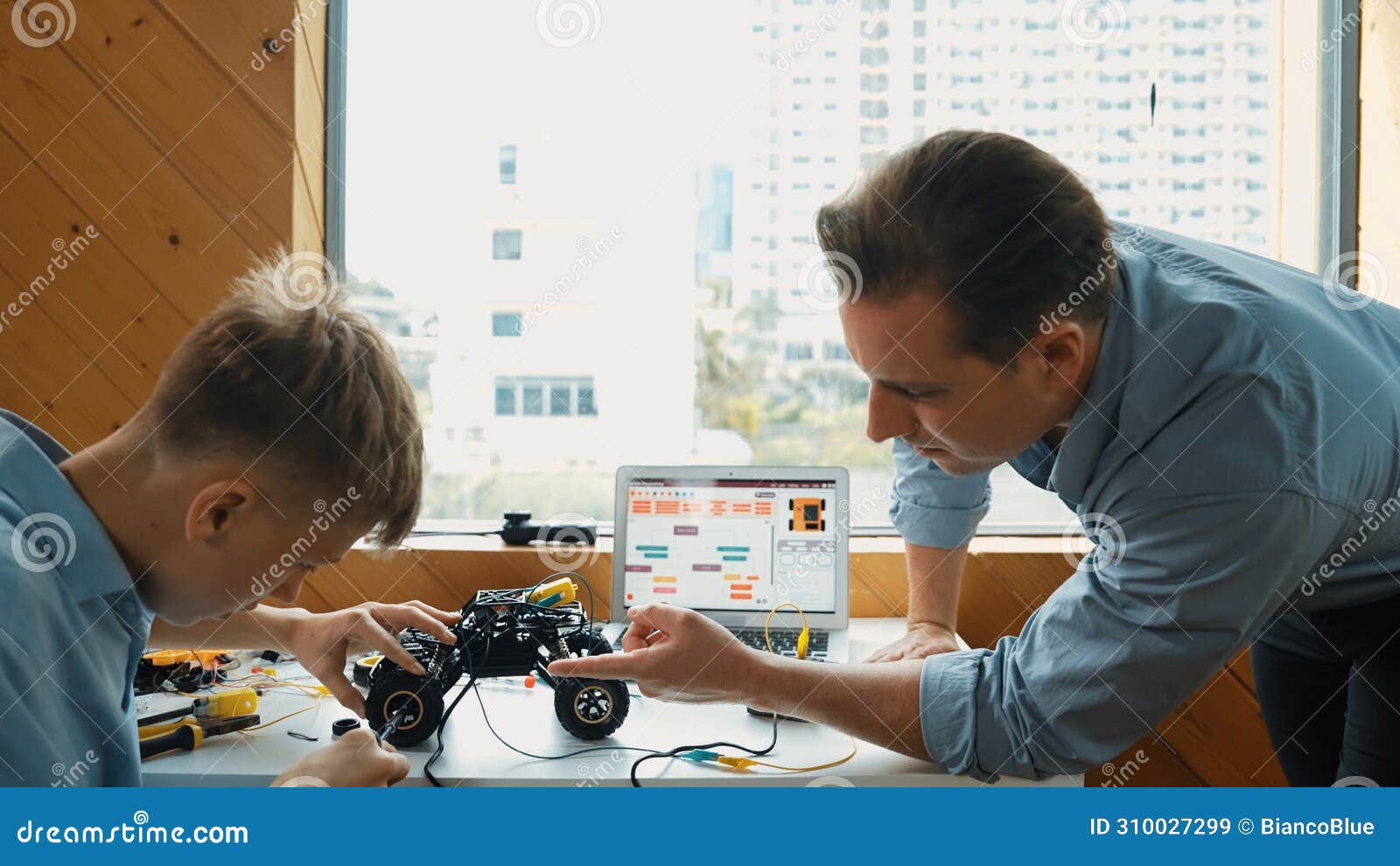 Teacher Help Student Fixing Car Model and Giving Advise at Class ...