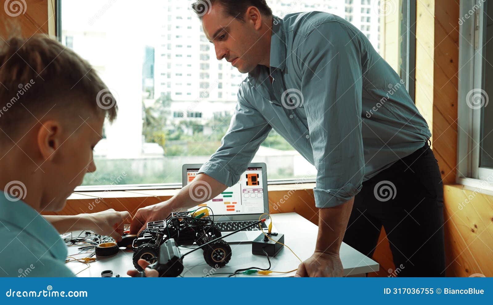 Teacher Help Student Fixing Car Model and Giving Advise at Class ...