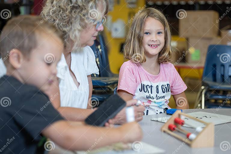 A Teacher is Helping a Child with a Math Problem Stock Image - Image of ...