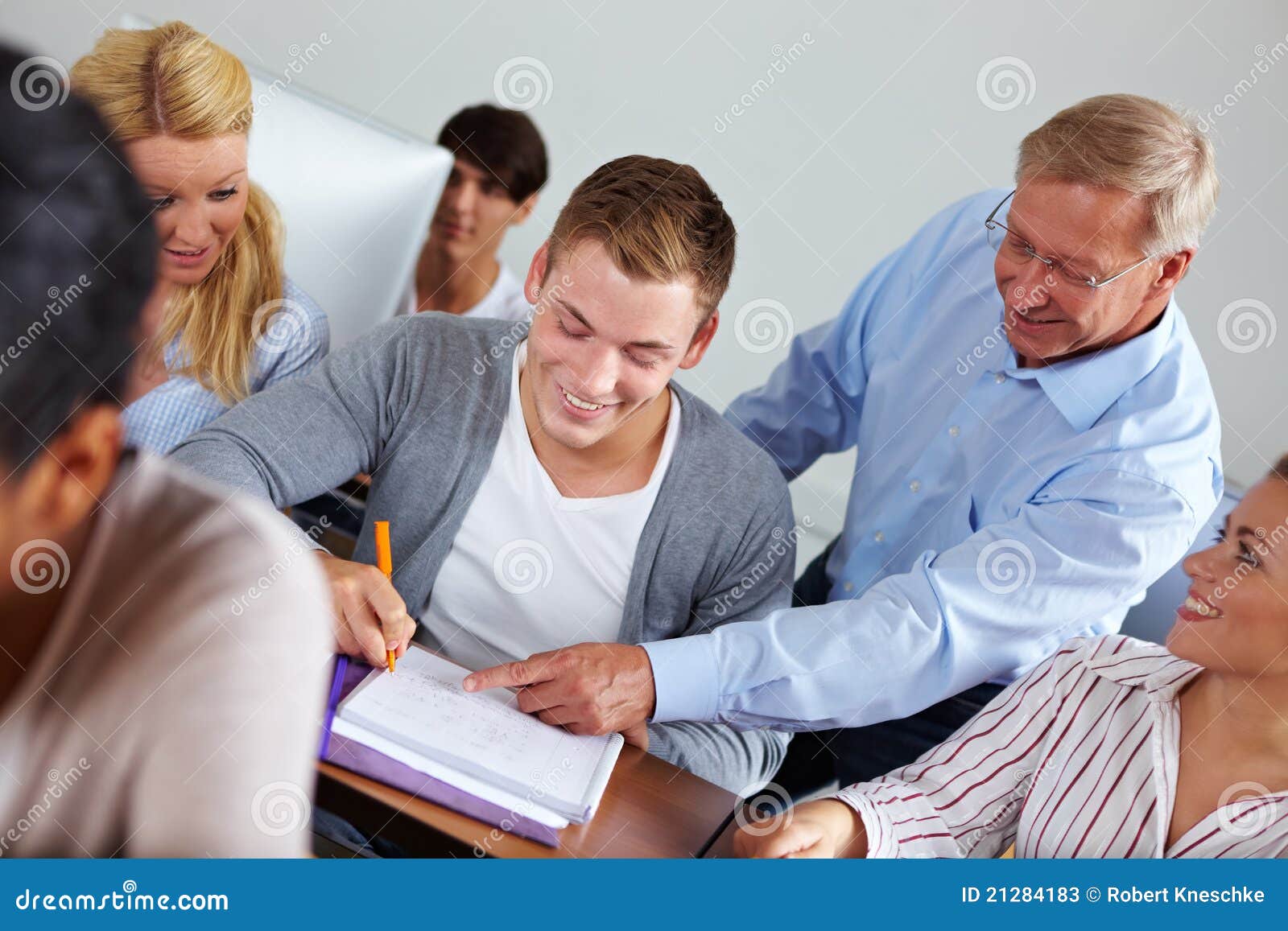 Teacher helping in class stock image. Image of education - 21284183