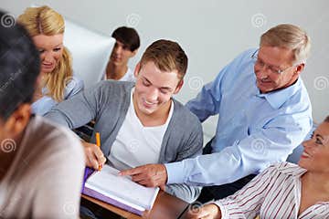 Teacher helping in class stock image. Image of education - 21284183