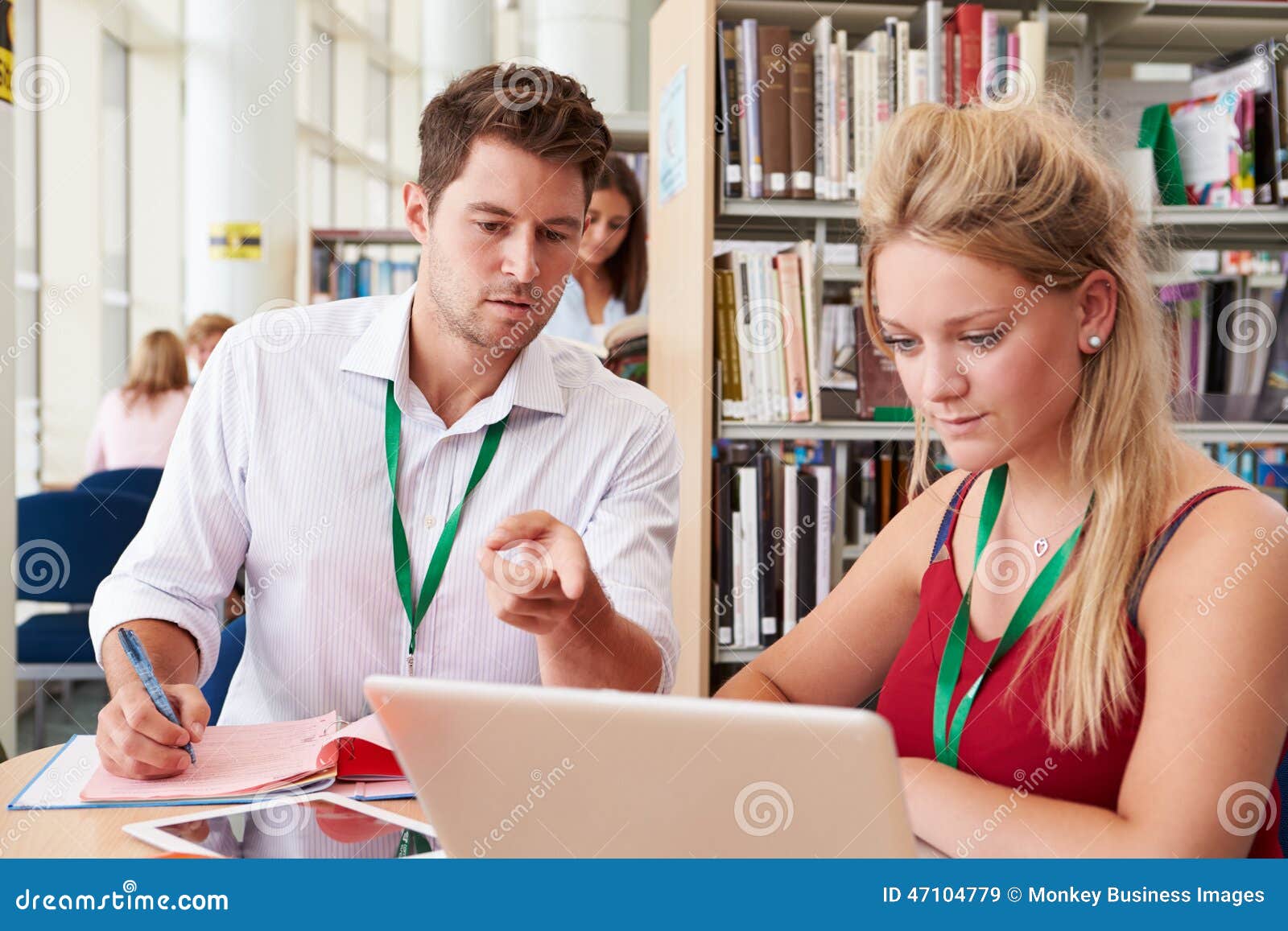 Teacher Helping College Student with Studies in Library Stock Image ...