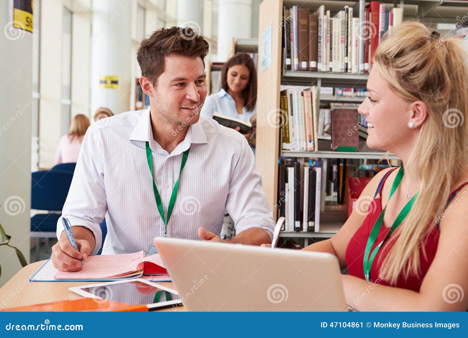 Teacher Helping College Student with Studies in Library Stock Image ...
