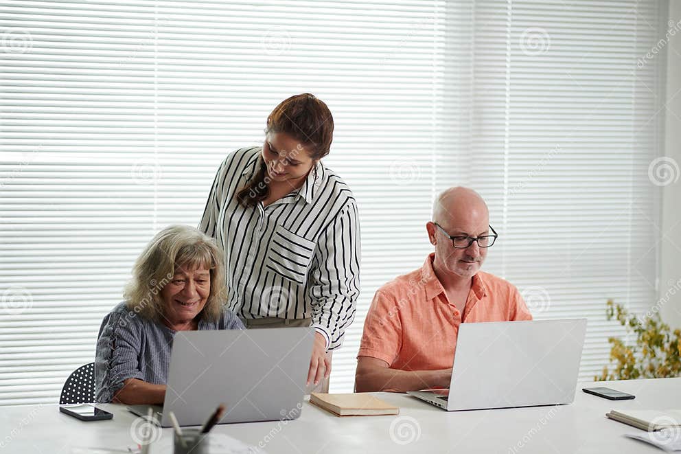 Teacher Helping Computer Class Students Stock Photo - Image of desk ...