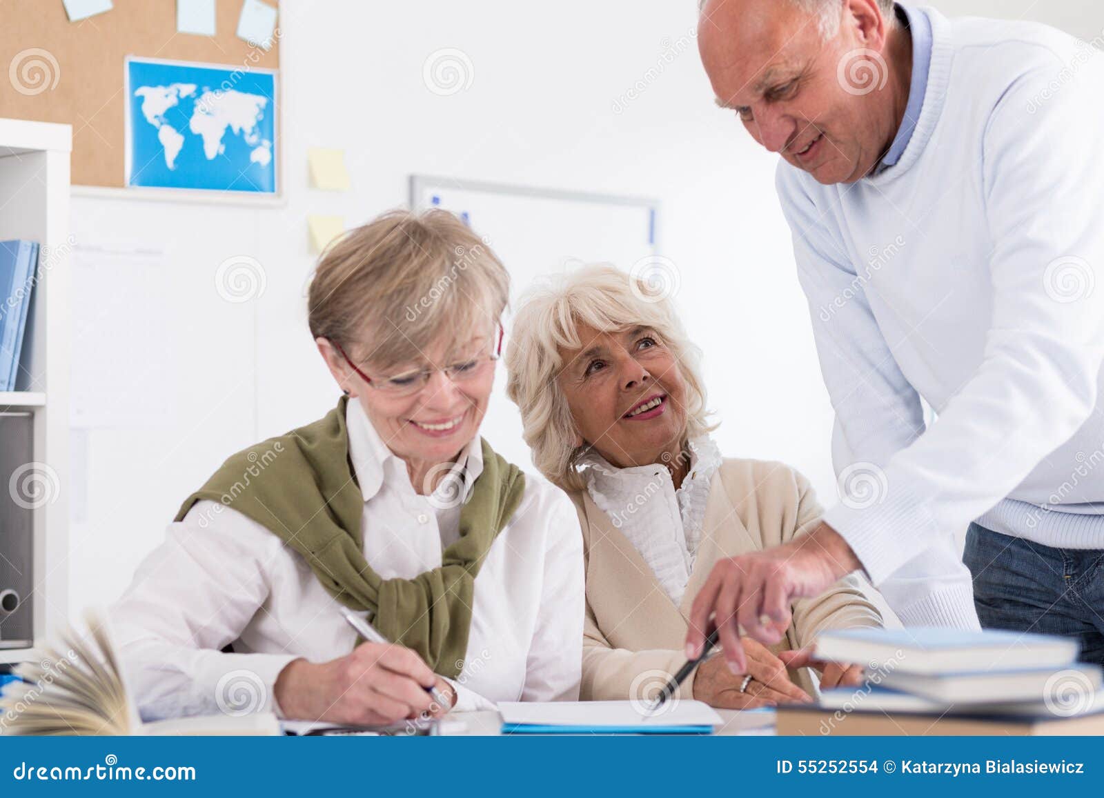 Teacher Helping Elder Student Stock Photo - Image of smile, elder: 55252554