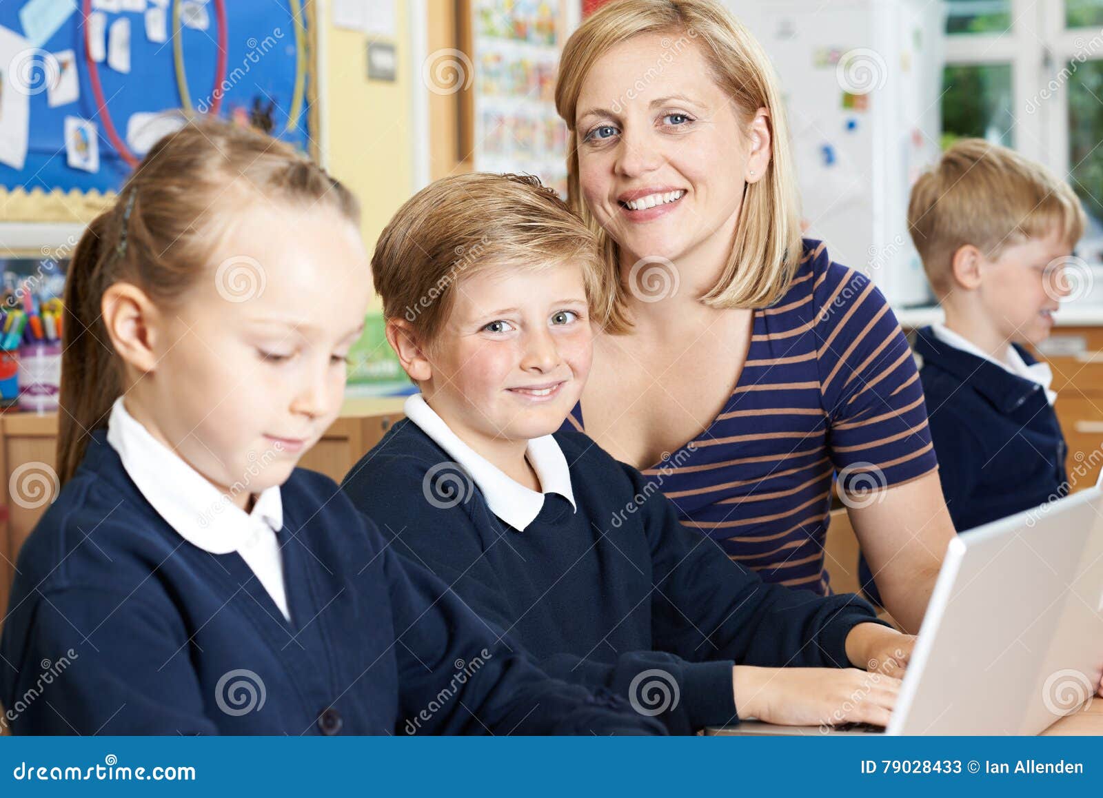 Teacher Helping Elementary School Pupils in Computer Class Stock Image ...