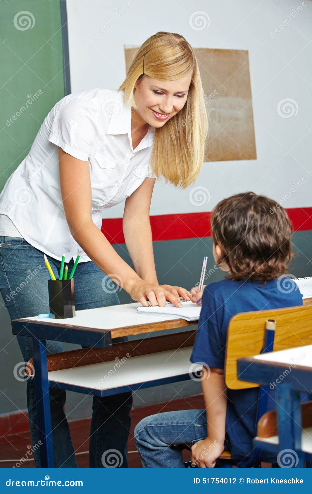 Teacher Helping Elementary School Student Stock Photo - Image of ...