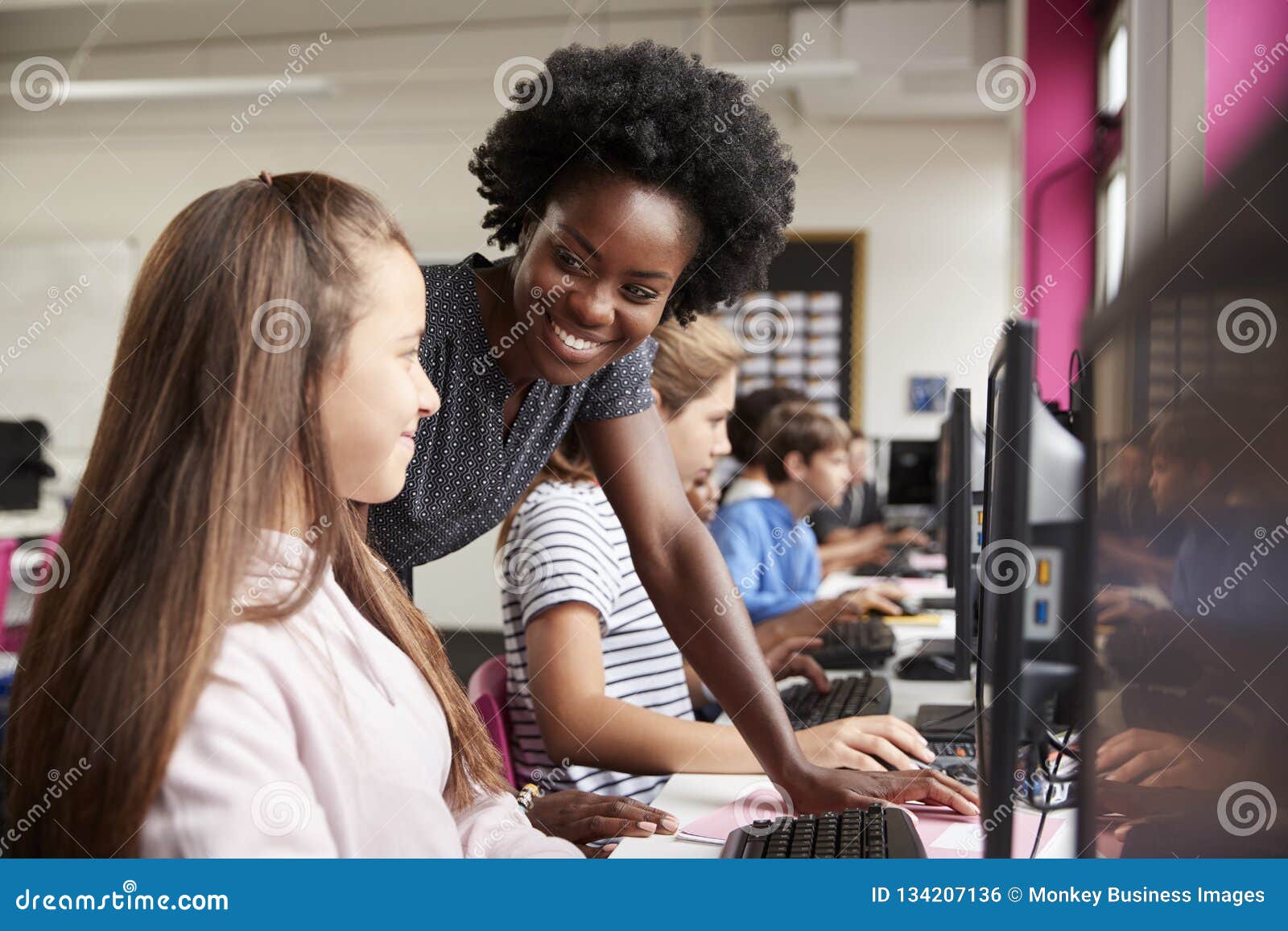 Teacher Helping Female Pupil Line of High School Students Working at ...
