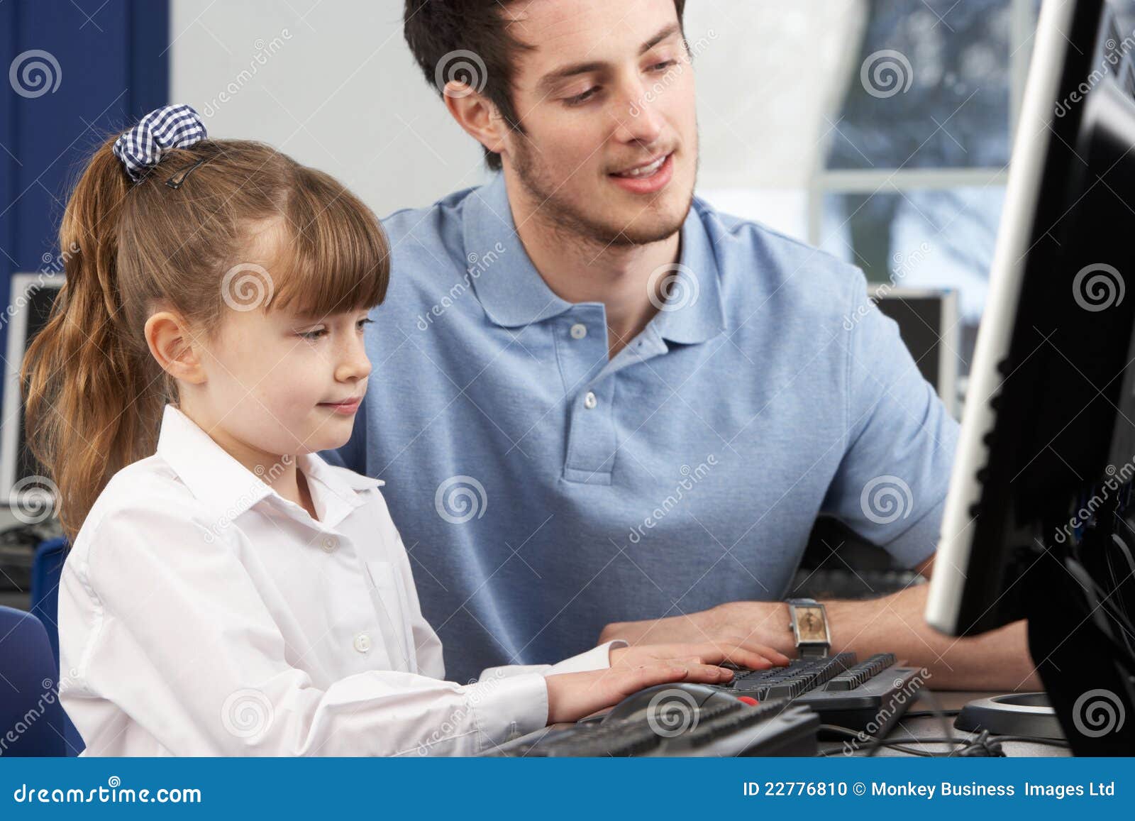 Teacher Helping Girl Using Computer In Class Stock Photo - Image of ...