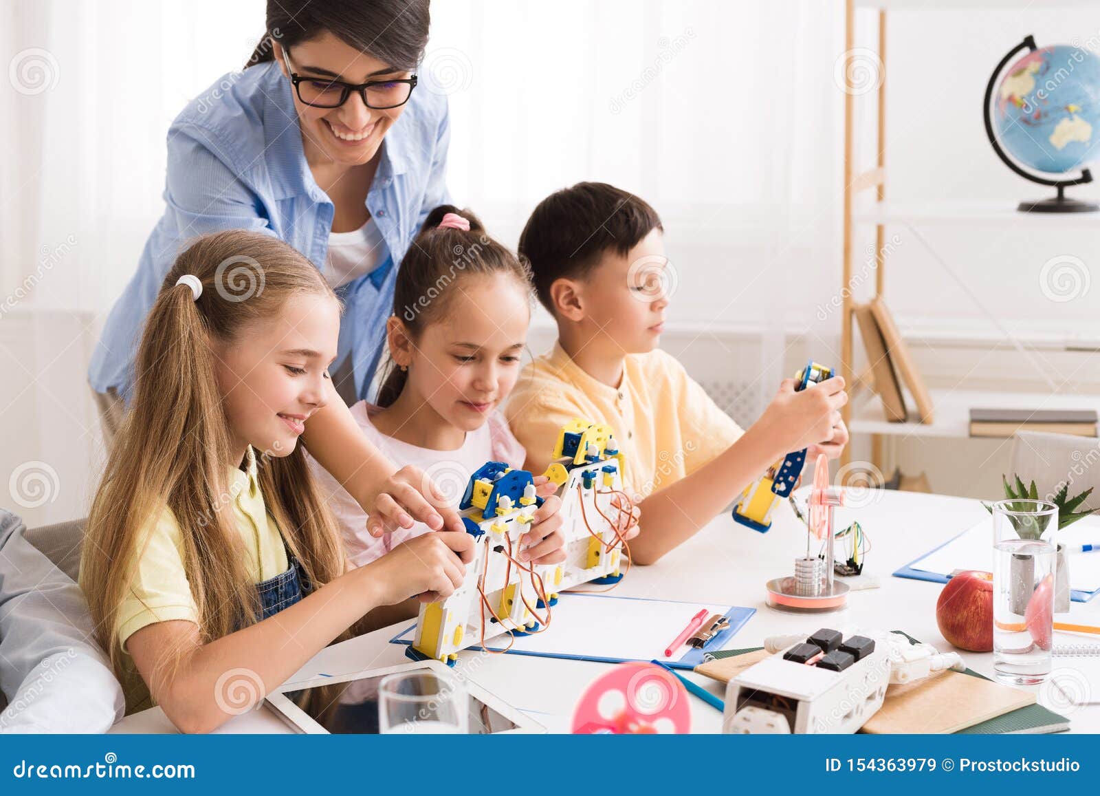 Teacher Helping Her Students with Diy Robots Stock Image - Image of ...