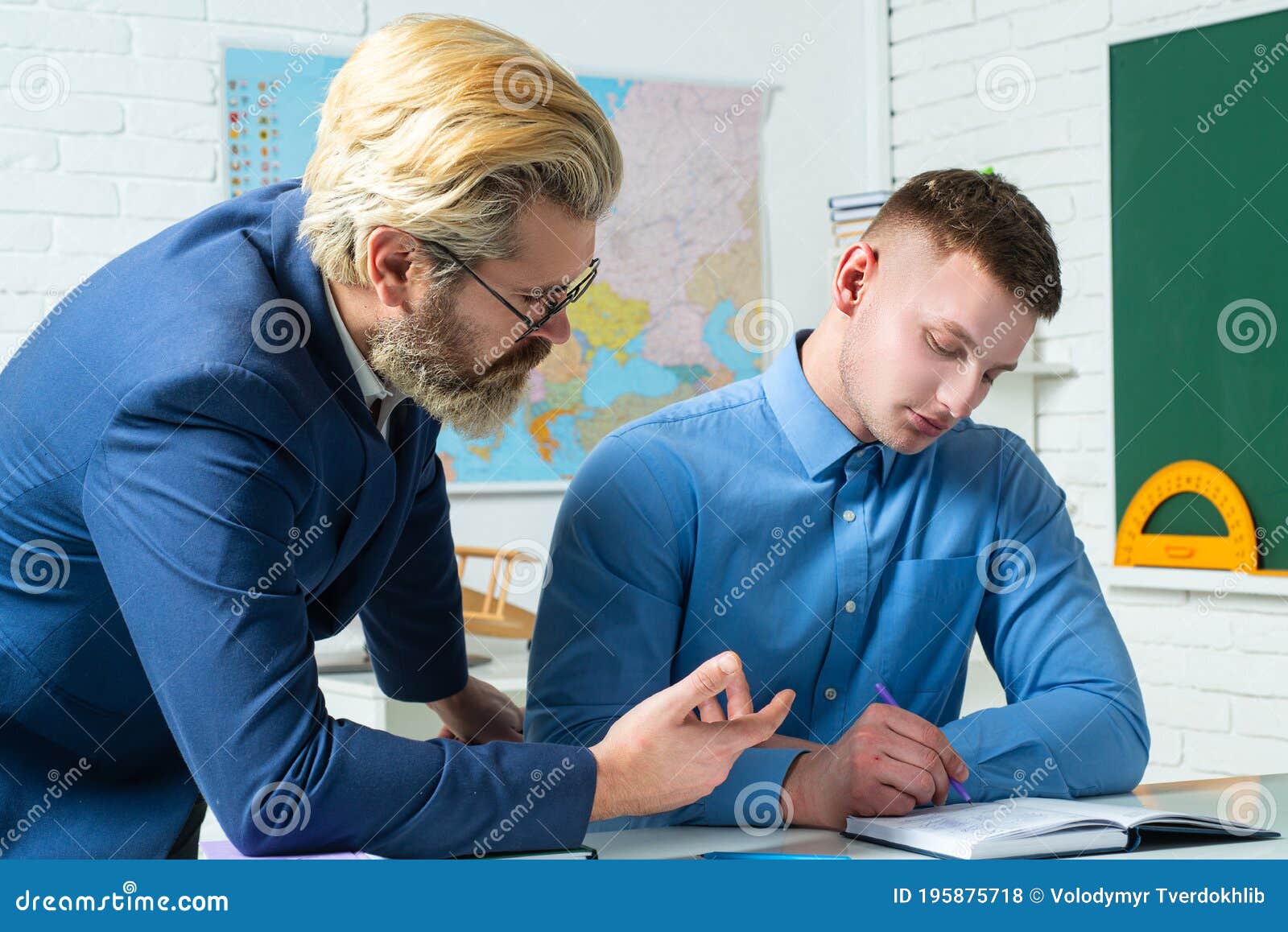 Teacher Helping High School Students. Student and Teacher on Exam in ...