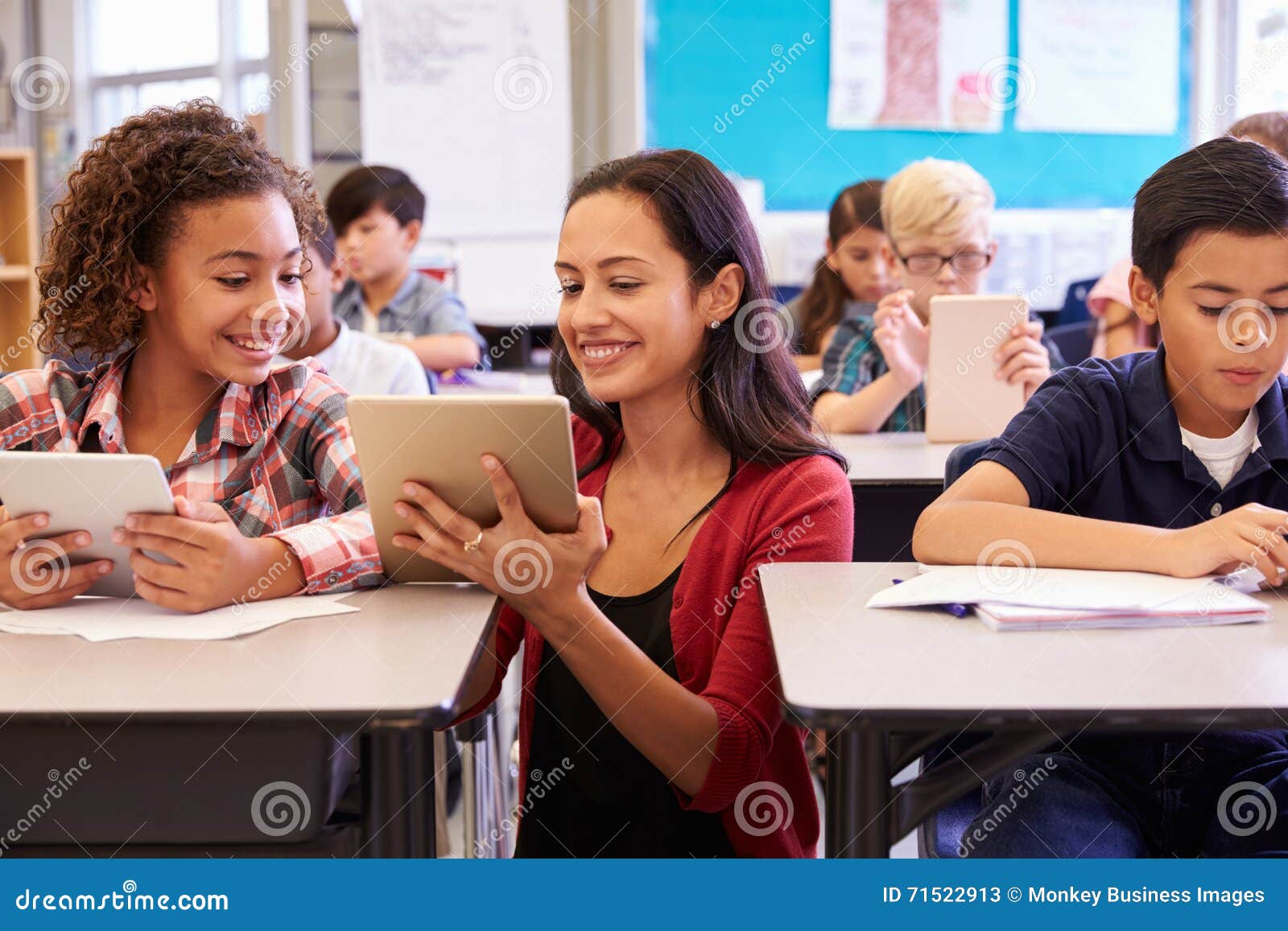 Teacher Helping Kids with Computers in Elementary School Stock Image ... Teacher Helping Kids with Computers in Elementary School Stock Image ...
