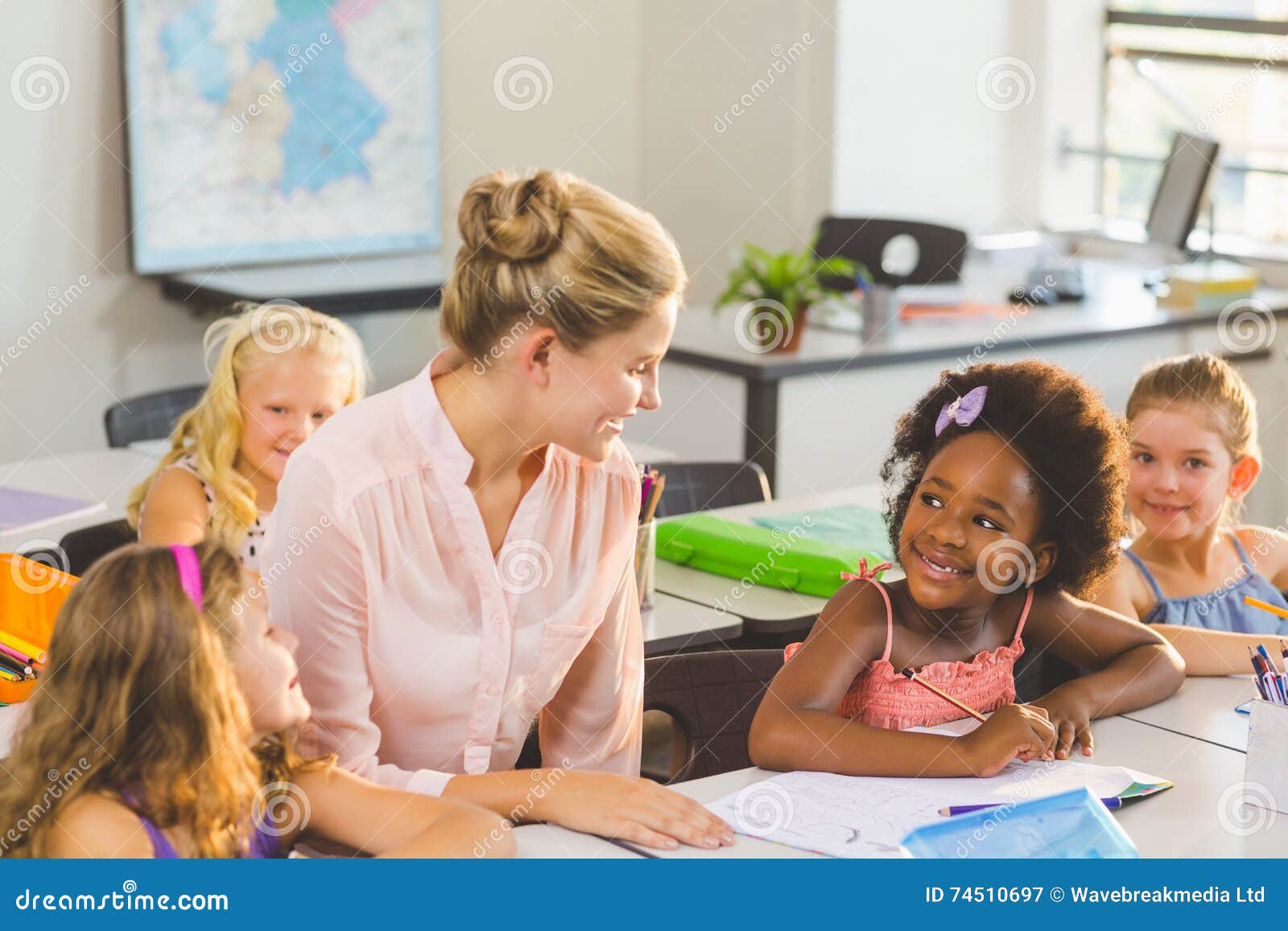 Teacher Helping Kids with Their Homework in Classroom Stock Image ...